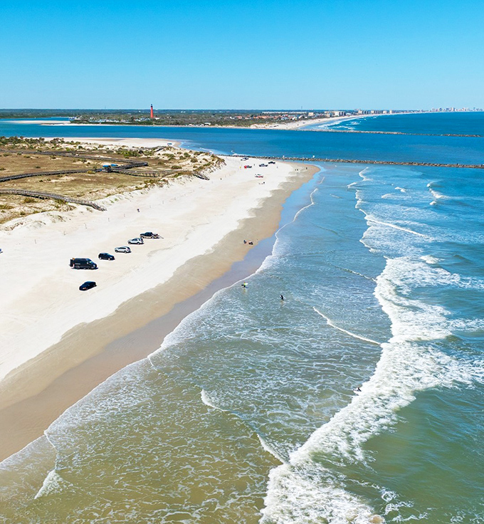 Smyrna Dunes Beach stretches into the distance, its pristine shoreline inviting visitors to leave footprints and take memories.