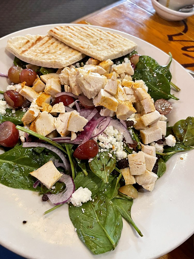 A spinach salad that's anything but ordinary – fresh greens, tender chicken, and a rainbow of toppings that make healthy eating feel indulgent.