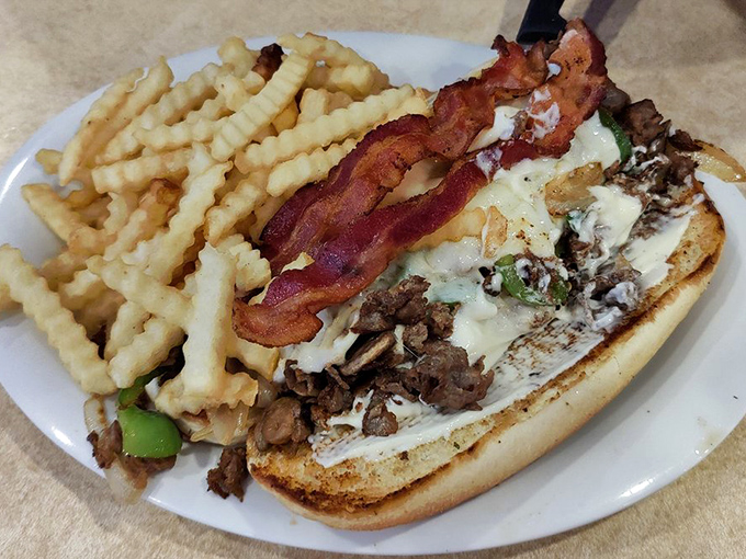 A steak and cheese sub that means business &ndash; tender beef, melted cheese, and crispy bacon nestled in a toasted roll.