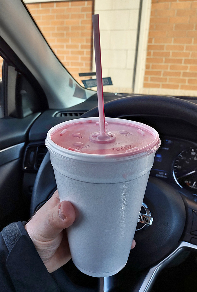 Strawberry milkshake thick enough to require serious commitment but worth every delicious struggle.