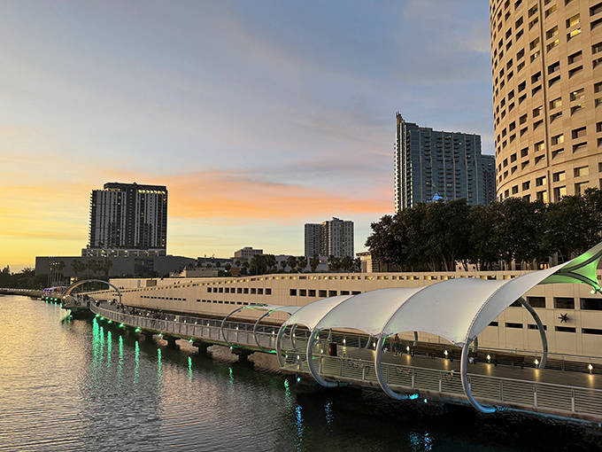 Sunset paints the Riverwalk in golden hues, transforming ordinary concrete and steel into a warm, glowing pathway between day and night.