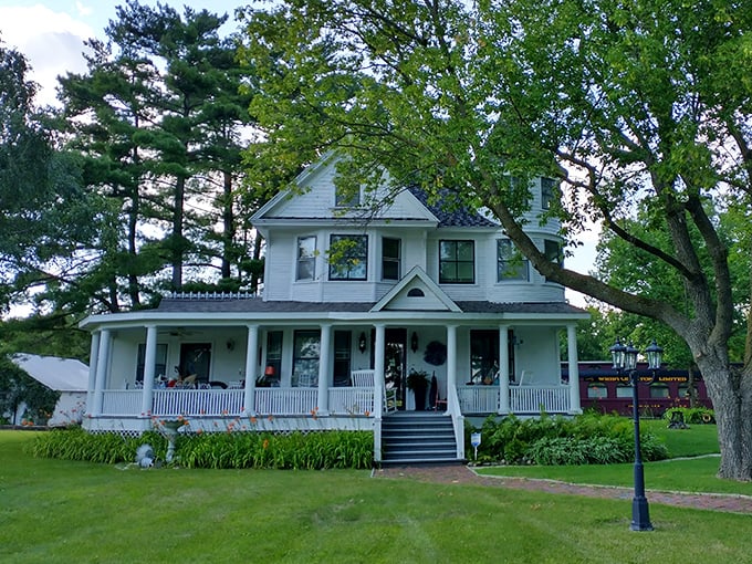 The main house stands with Victorian dignity, its wraparound porch practically demanding you sit a spell with lemonade.