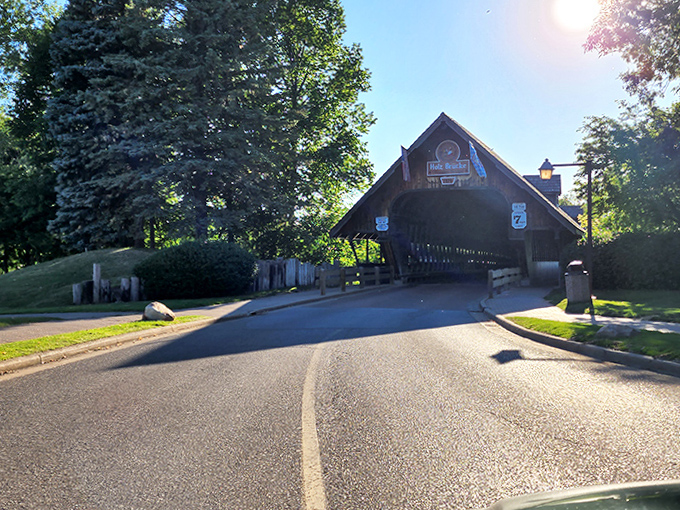 The welcoming entrance beckons visitors with its distinctive Bavarian design, standing as a wooden portal between everyday Michigan and a slice of Alpine Europe.