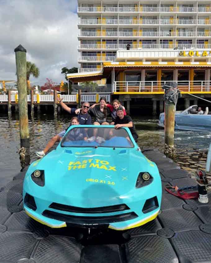 Nothing says "we're making memories" quite like a group photo in a vehicle that's having an identity crisis between being a car and a boat.