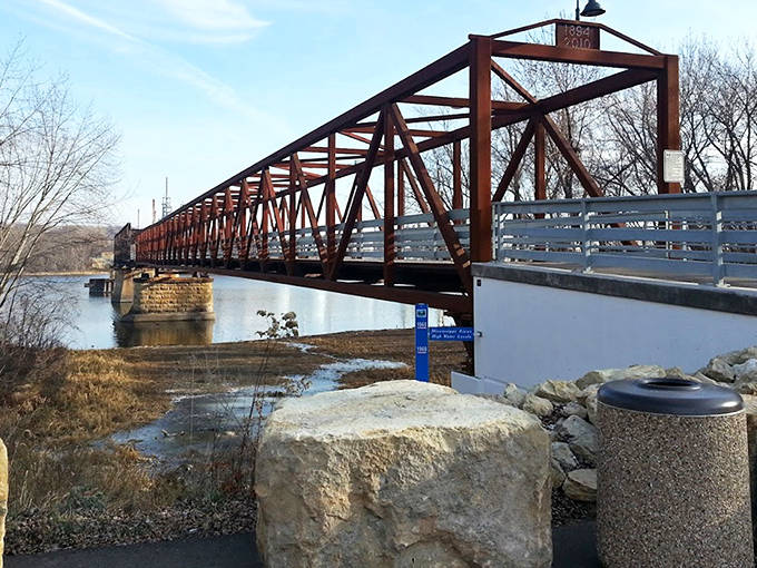 A commemorative stone tells the tale of community effort that transformed an abandoned bridge into a beloved public space.