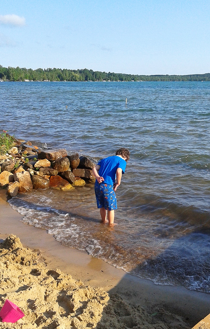 Childhood curiosity meets nature's playground &ndash; where simple shoreline explorations become treasured memories.