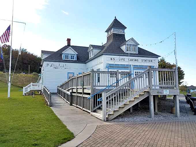 The historic Life Saving Station stands sentinel over the waters, its white facade gleaming with stories of courage and Michigan maritime history.