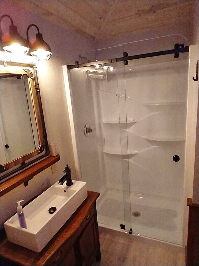 Enjoy a modern refresh in our sleek glass shower, blending contemporary comfort with the industrial charm of the rails.