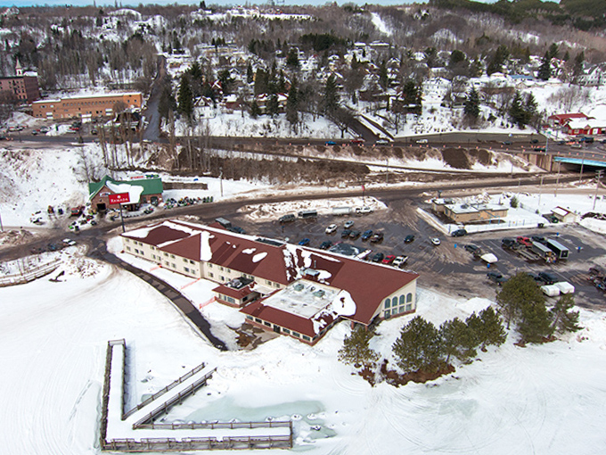 Winter transforms Hancock into a snow-covered wonderland, with buildings nestled against white hillsides and smoke curling from saunas throughout town.