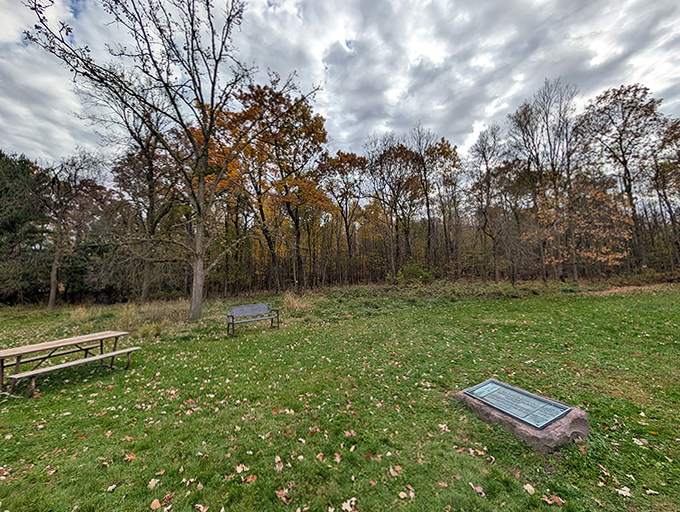 Autumn leaves scatter across this quiet corner of the park, where benches invite contemplation of mysteries a millennium in the making.