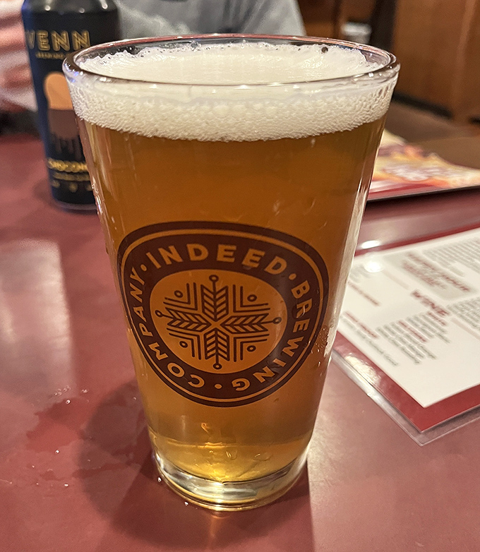 A perfectly poured local brew stands ready to cool the flames of molten cheese &ndash; the unsung hero of every Juicy Lucy adventure.