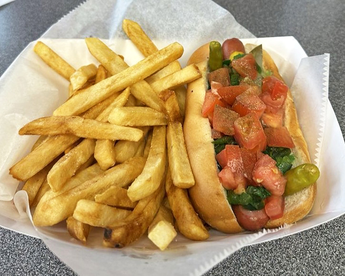 Another angle on perfection&mdash;fresh tomatoes, pickle, and that signature poppy seed bun. Some people frame artwork; I'd rather eat it.