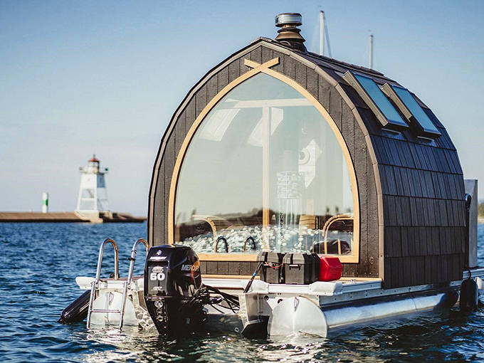 The floating sauna's large window frames Lake Superior like a living painting, bringing the outside in while keeping the cold out.