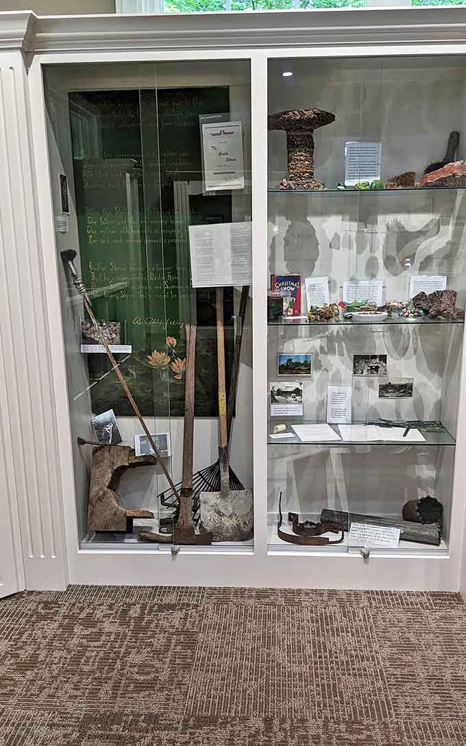 Cultural artifacts displayed behind glass tell the story of the garden's creation, tools of transformation preserved for future generations.