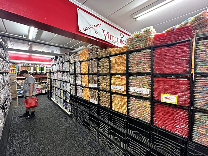 A shopper navigates the candy wonderland with the focused determination of someone on an important mission – finding the perfect sweet souvenir.