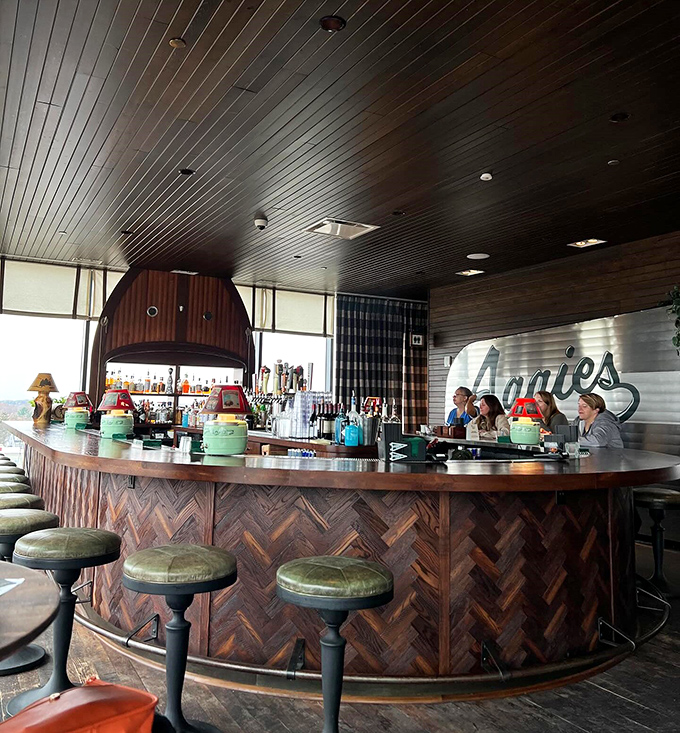 The circular wooden bar creates a natural gathering spot where strangers become friends over locally-inspired libations.