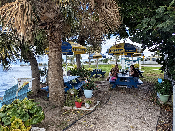 Diners: Under the dappled shade of palm trees, locals gather at blue tables to enjoy the simple pleasure of great food with million-dollar views.