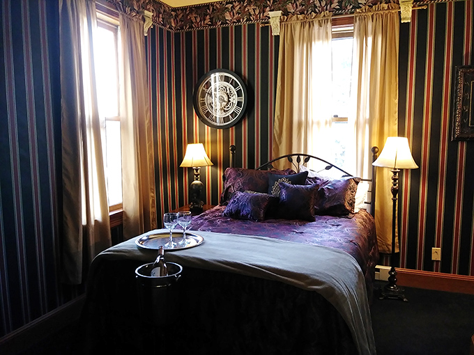 Bold striped wallpaper creates drama in this room, though the real drama might come from unexplained footsteps at 3 AM.