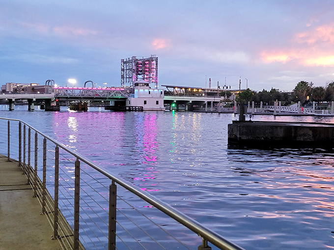Sunset paints the Riverwalk bridge in cotton candy colors. Even the water seems to hold its breath at this magical moment.