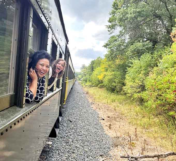 Joy finds its purest expression as passengers lean out windows, their faces illuminated by the simple pleasure of wind, speed, and spectacular scenery.
