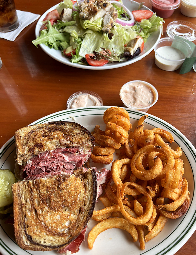 House-corned beef stacked high on marbled rye with melted Swiss and tangy sauerkraut &ndash; a sandwich that demands to be eaten with both hands.