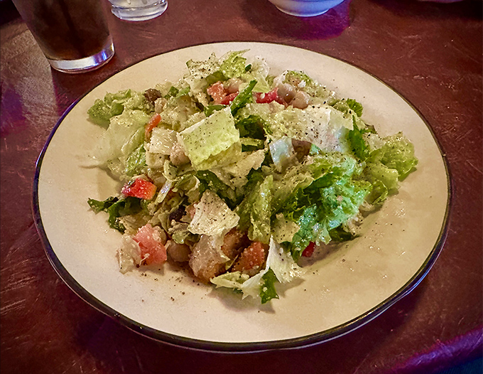 Crisp romaine leaves playing host to a gathering of croutons and Parmesan, all united by a dressing that balances garlic punch with creamy richness.