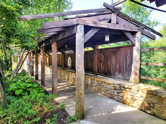 This rustic covered walkway guides visitors through the grounds, offering shade and architectural character with every wooden beam.