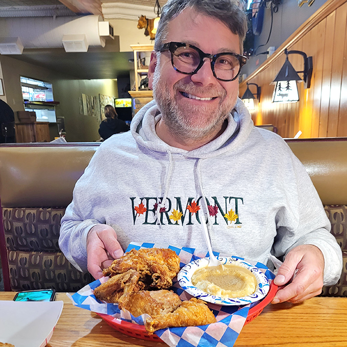 A patron enjoying the fruits of The Brass Rail's labor &ndash; that look of contentment is the universal expression of someone experiencing chicken nirvana.