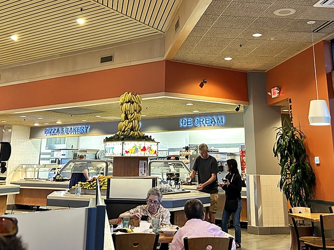 The banana tower stands sentinel over the dining area, a yellow monument to freshness and the promise of perfectly ripened fruit for your sundae.