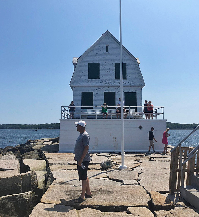 A close-up reveals the distinctive lantern room, where lighthouse keepers once maintained the beacon that guided countless mariners to safety.