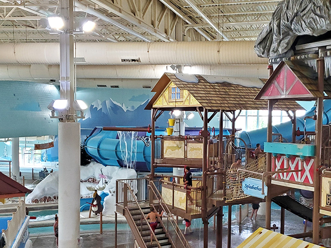 Vibrant waterslides snake through the Alpine-themed interior, where fake snow decorations ironically complement the tropical temperature maintained year-round.
