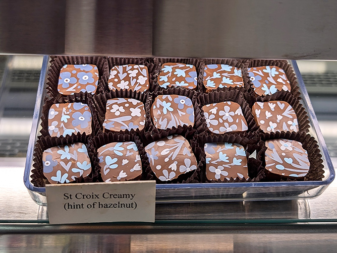 Hazelnut chocolates decorated with delicate white chocolate lace, proving that classic flavors deserve presentation worthy of their timeless deliciousness and refined taste.