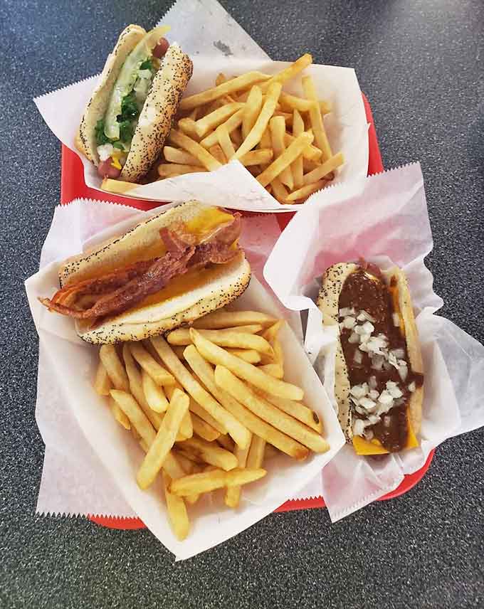 A hot dog spread that looks like it's ready for its close-up, each one dressed to impress and loaded with enough toppings to require strategic eating.