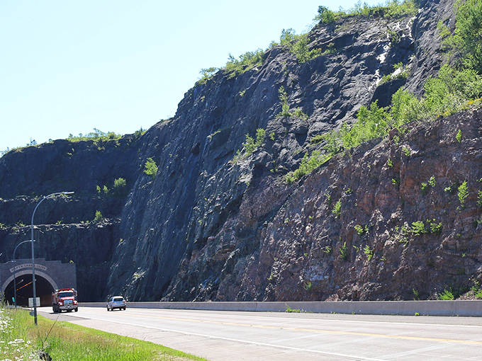 Silver Creek Cliff's imposing presence reminds visitors of nature's raw power, with the tunnel representing humanity's clever response to this geological challenge.