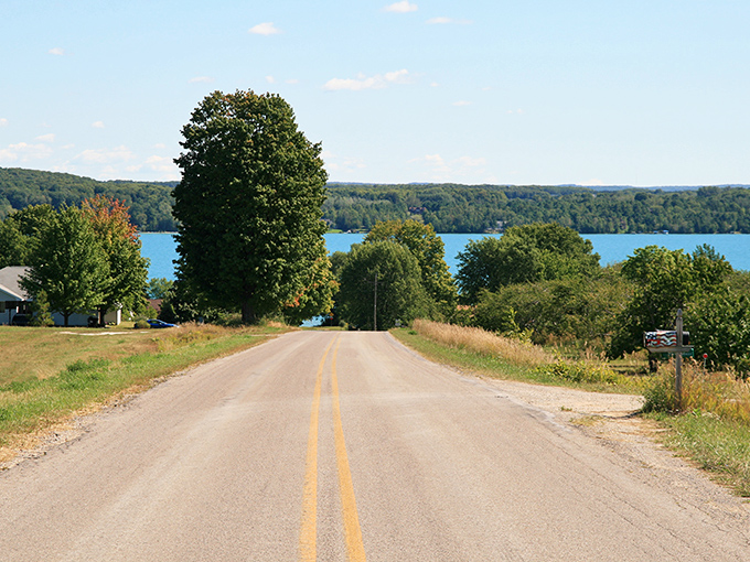 The road to paradise has yellow lines! Elk Lake reveals itself dramatically as you crest this Michigan hillside.