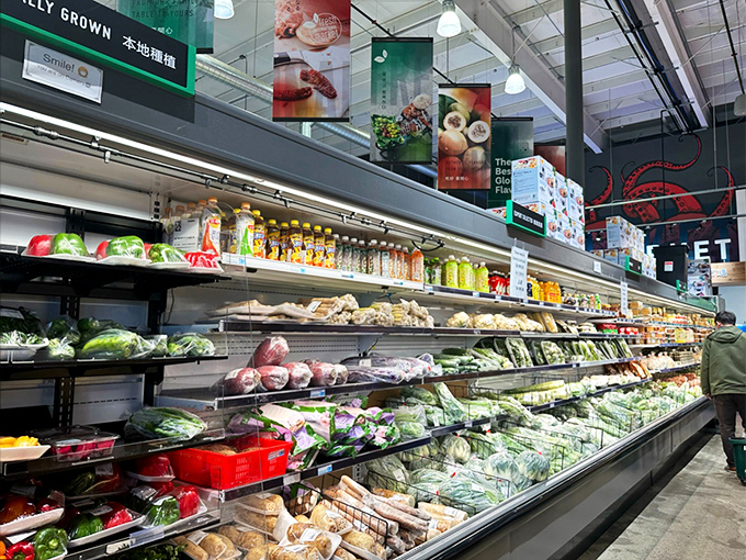Vibrant greens and vegetables create a produce rainbow, many rarely seen in typical supermarkets but essential for authentic Asian cooking techniques.
