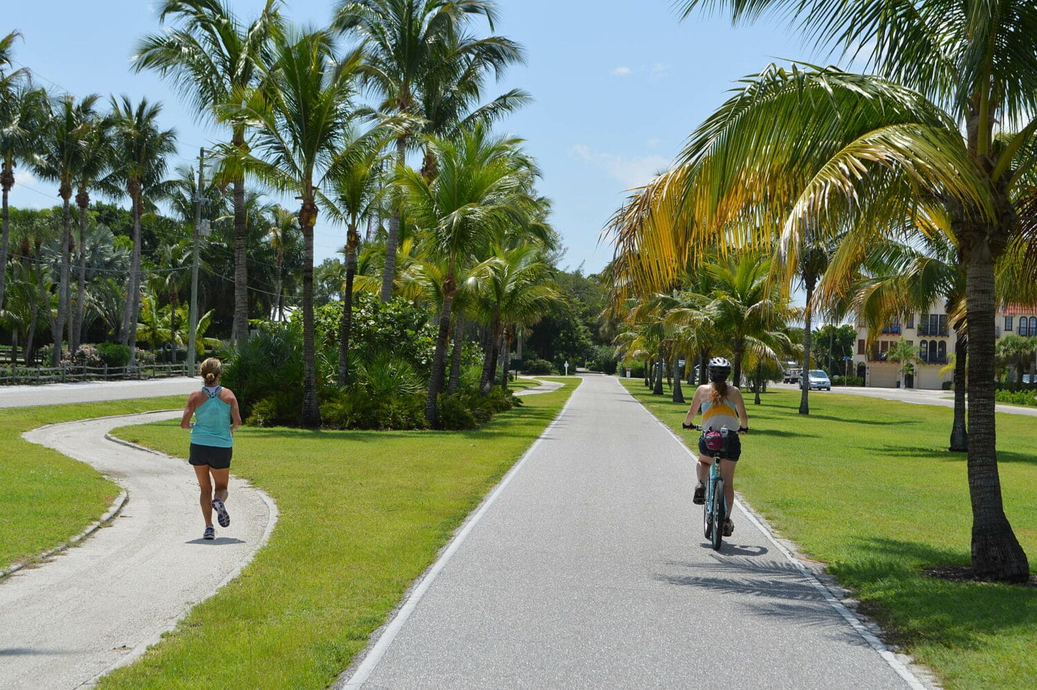 A biker and a runner in the paved trail