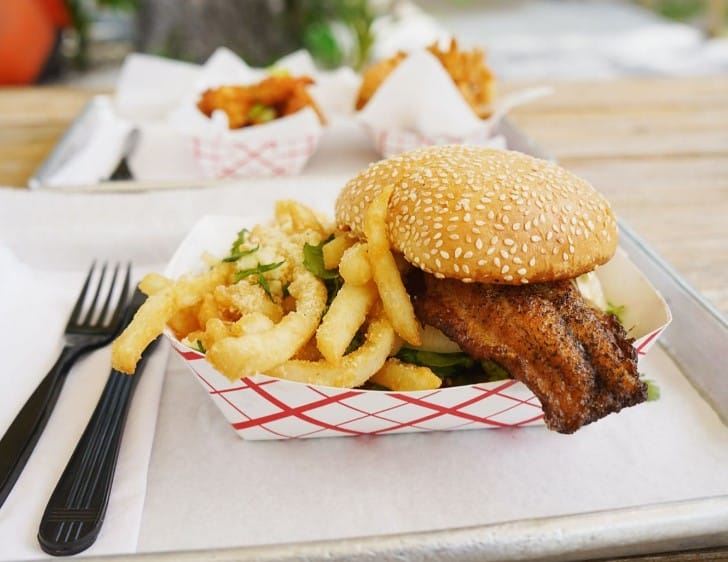 a grouper sandwich with a side of french fries