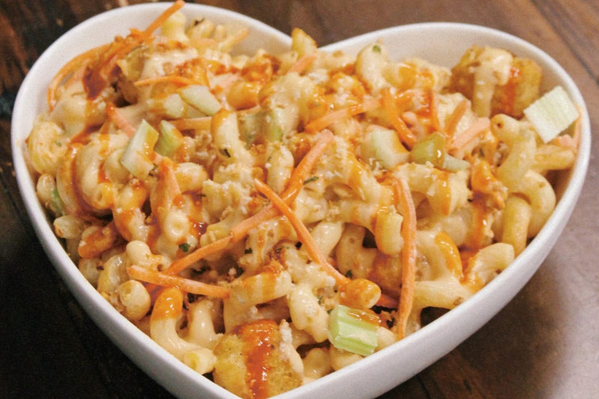 A heart shaped bowl of Buffalo Blue Mac & Cheese