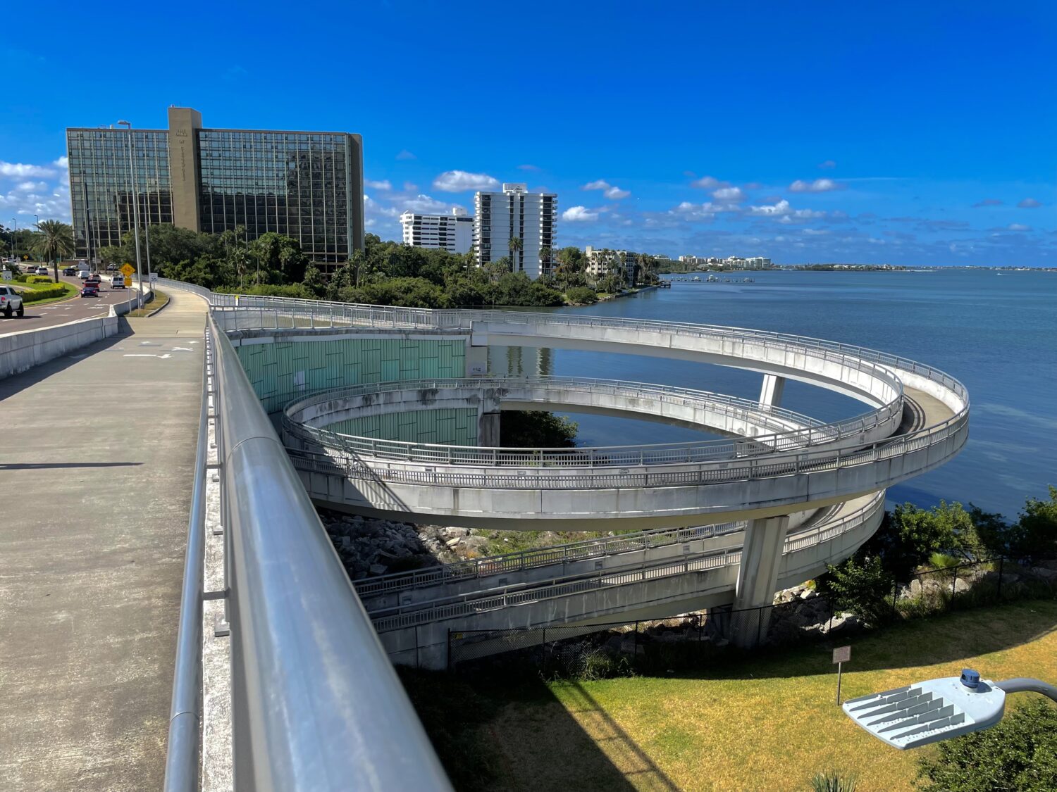 a part of the memorial causeway bike trail on the bridge with views of the water and a circular path