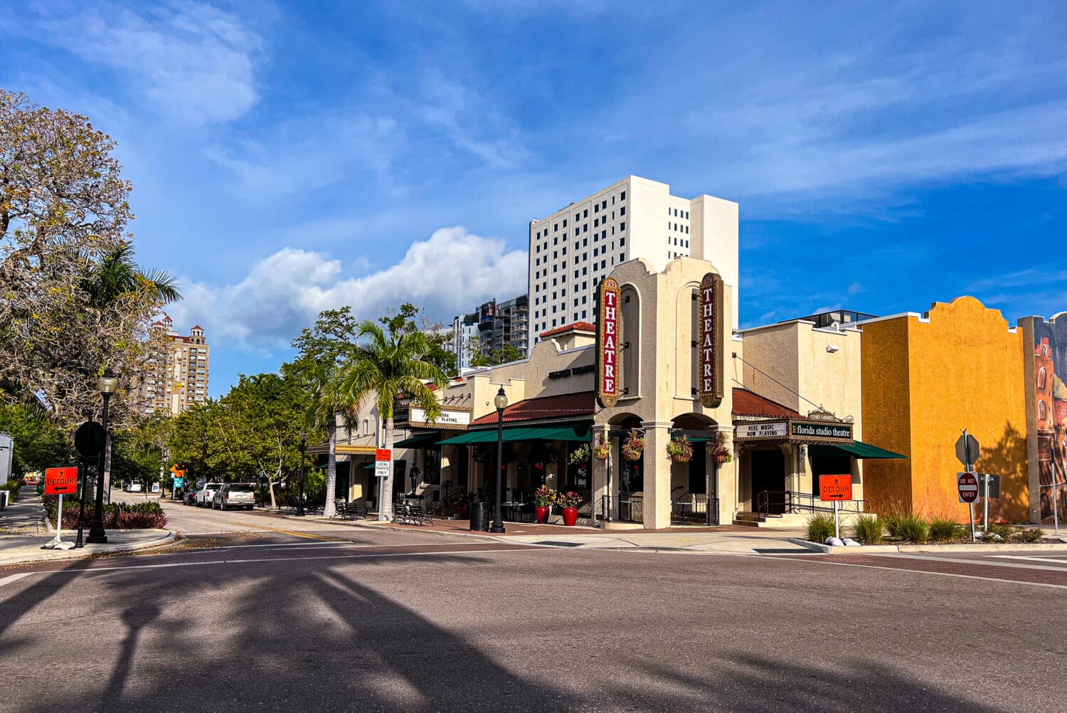 a photo of the theater beside a main road on a clear day