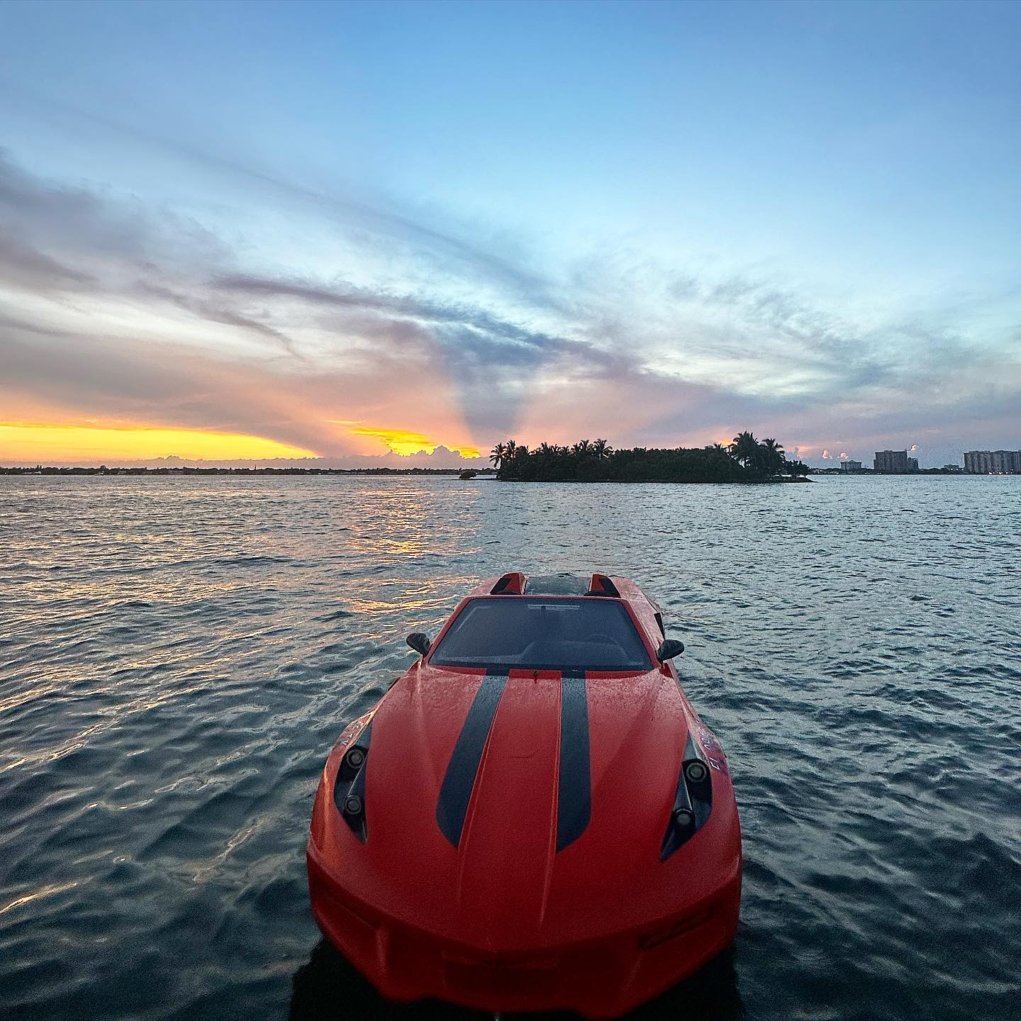 a red jet car with the stunning sunset on the background