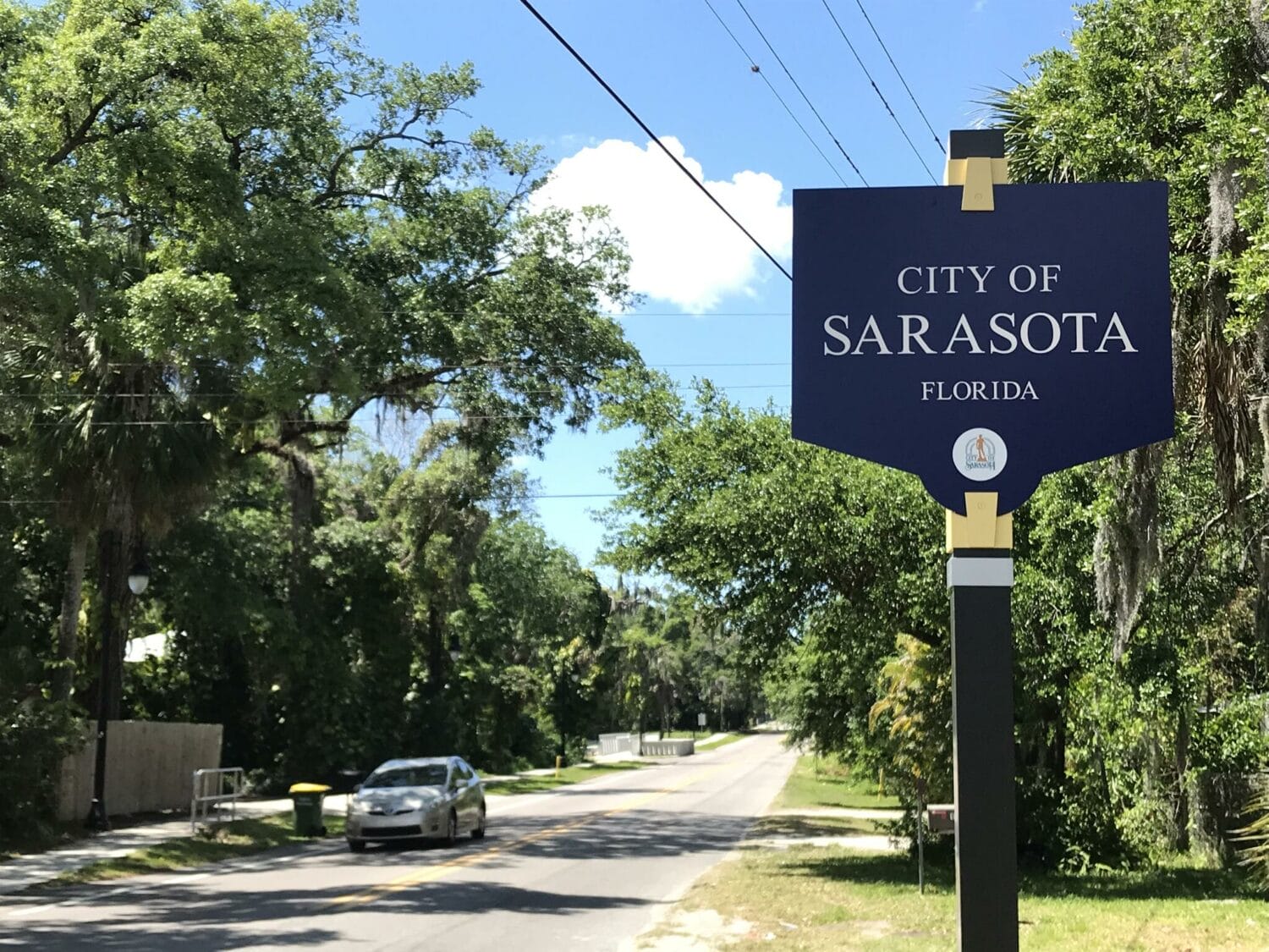 a signage of sarasota beside a road