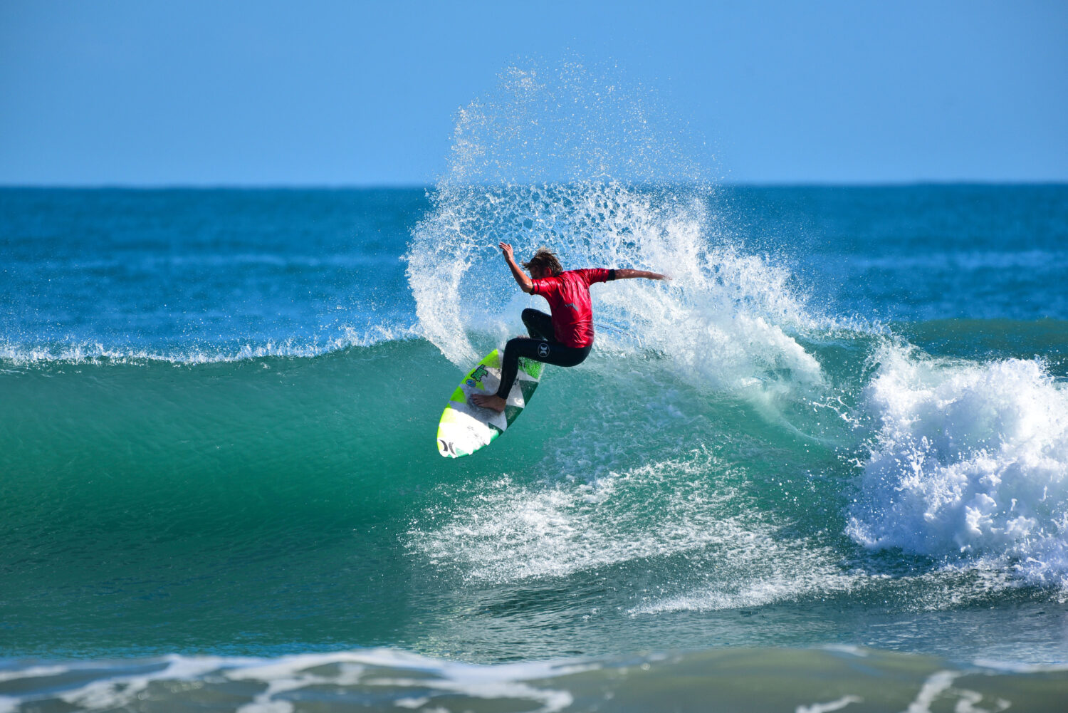 a surfer riding the waves of hobe sound beach