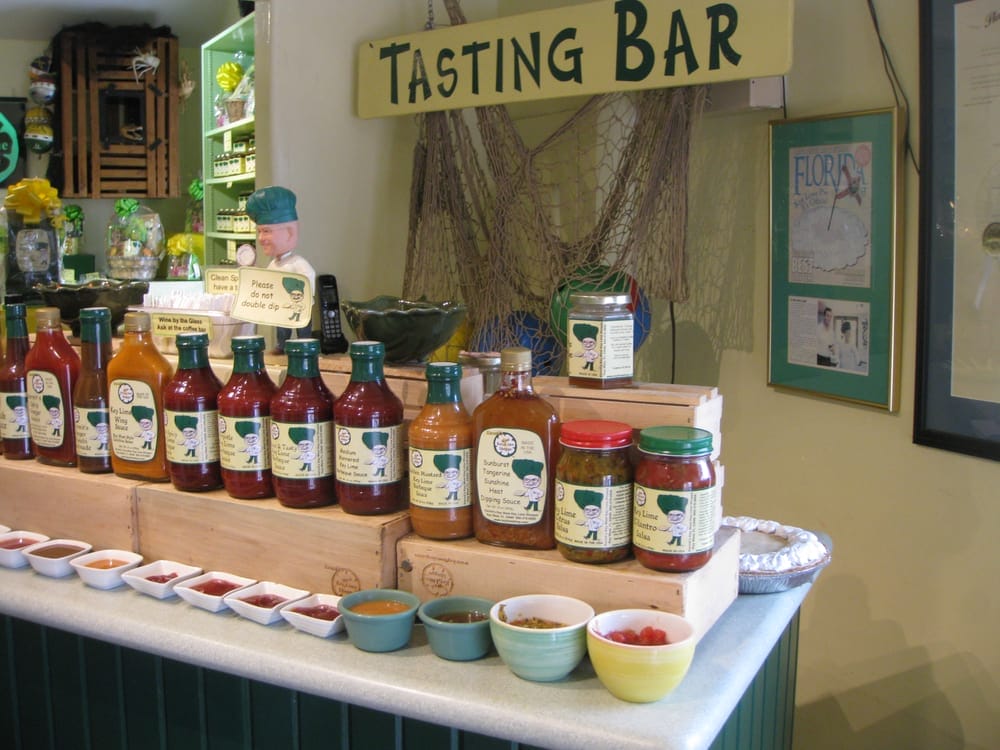 A tasting bar of different key lime sauces and salsas