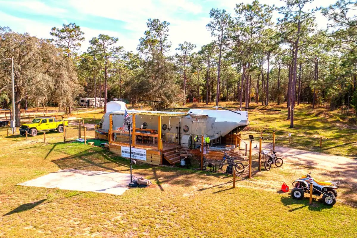 aerial view of the gigantic helicopter airbnb in the middle of the forest