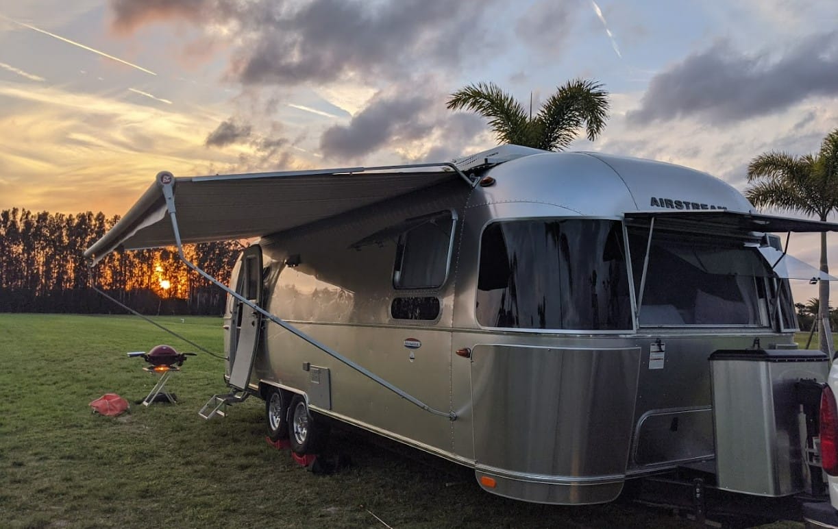an rv packed with camping essentials in summer crush vineyard winery