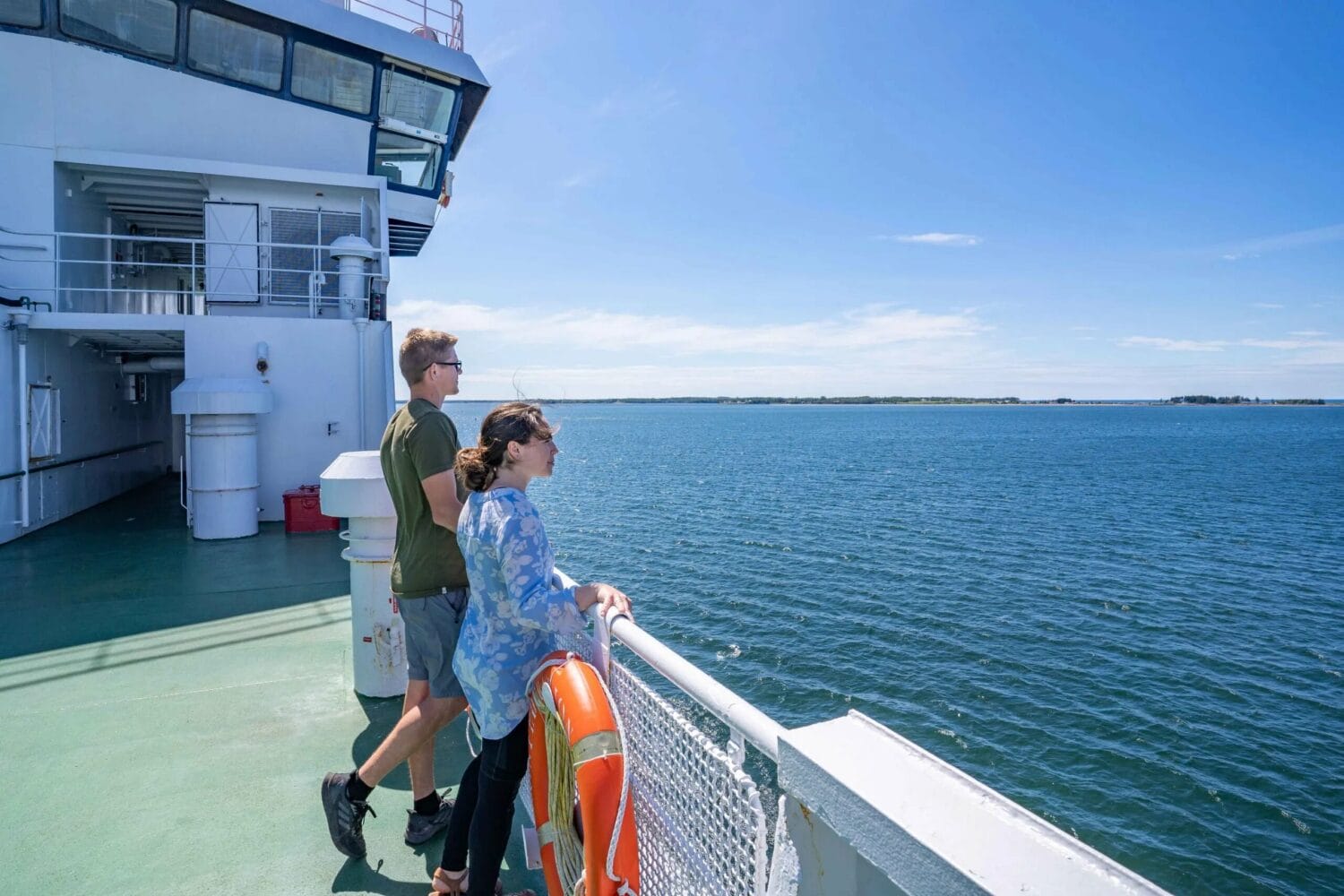 Couple enjoying the view on the ferry on their way to the island