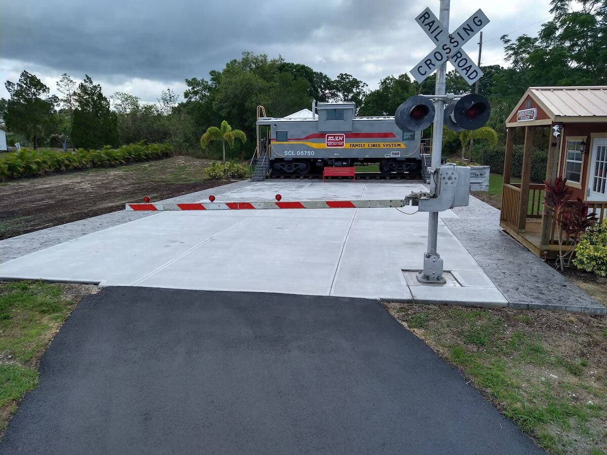 exterior of the caboose blocked by a level crossing gate
