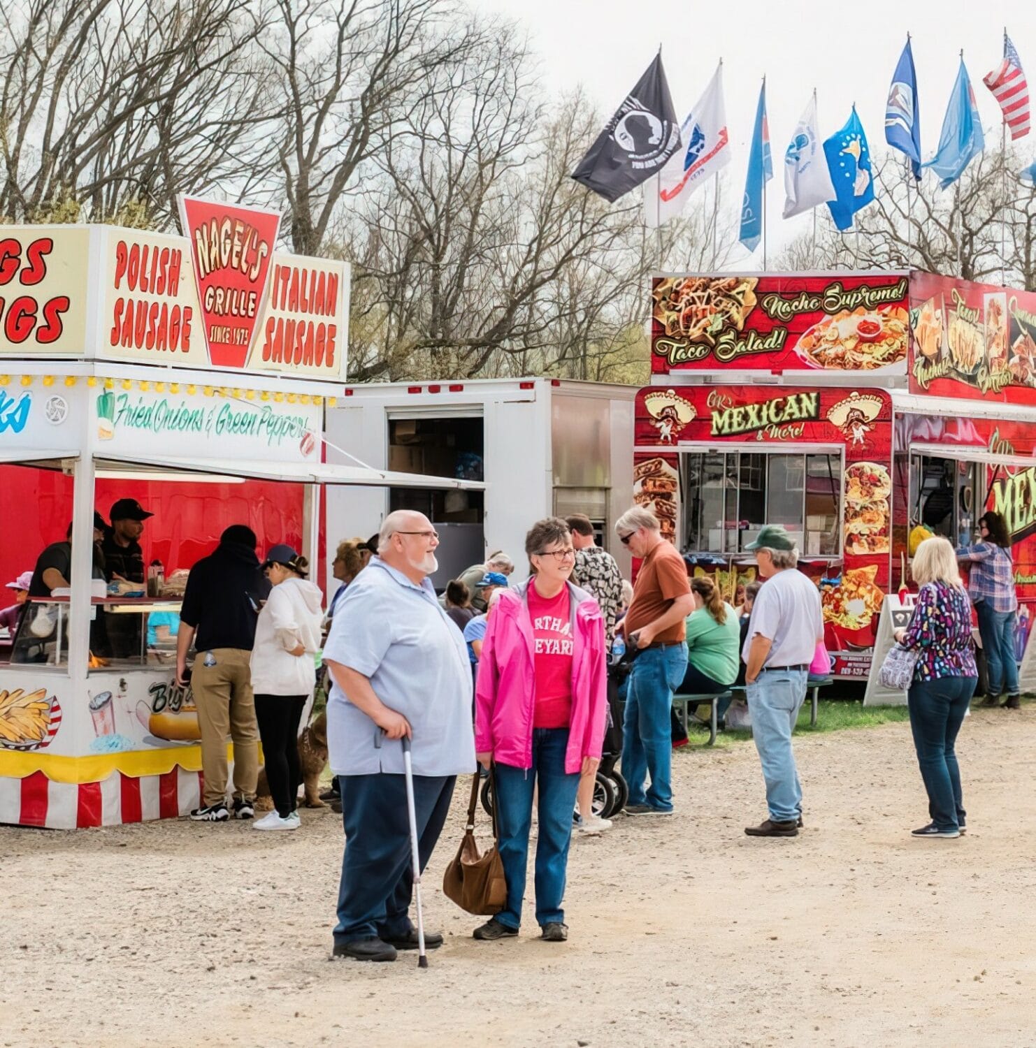 food stalls offering a variety of snacks at the flea market, with flags flying and people mingling